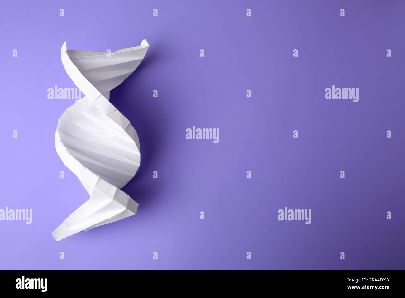 Paper model of DNA molecular chain on violet background, top view ...