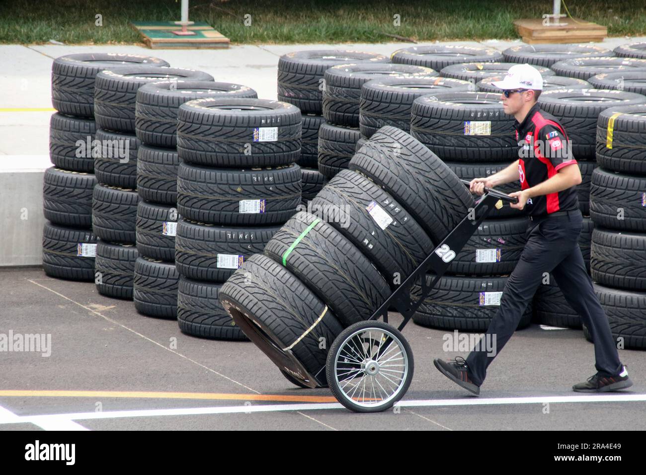 Pit crew workers move tires to prepare them for the inaugural NASCAR ...
