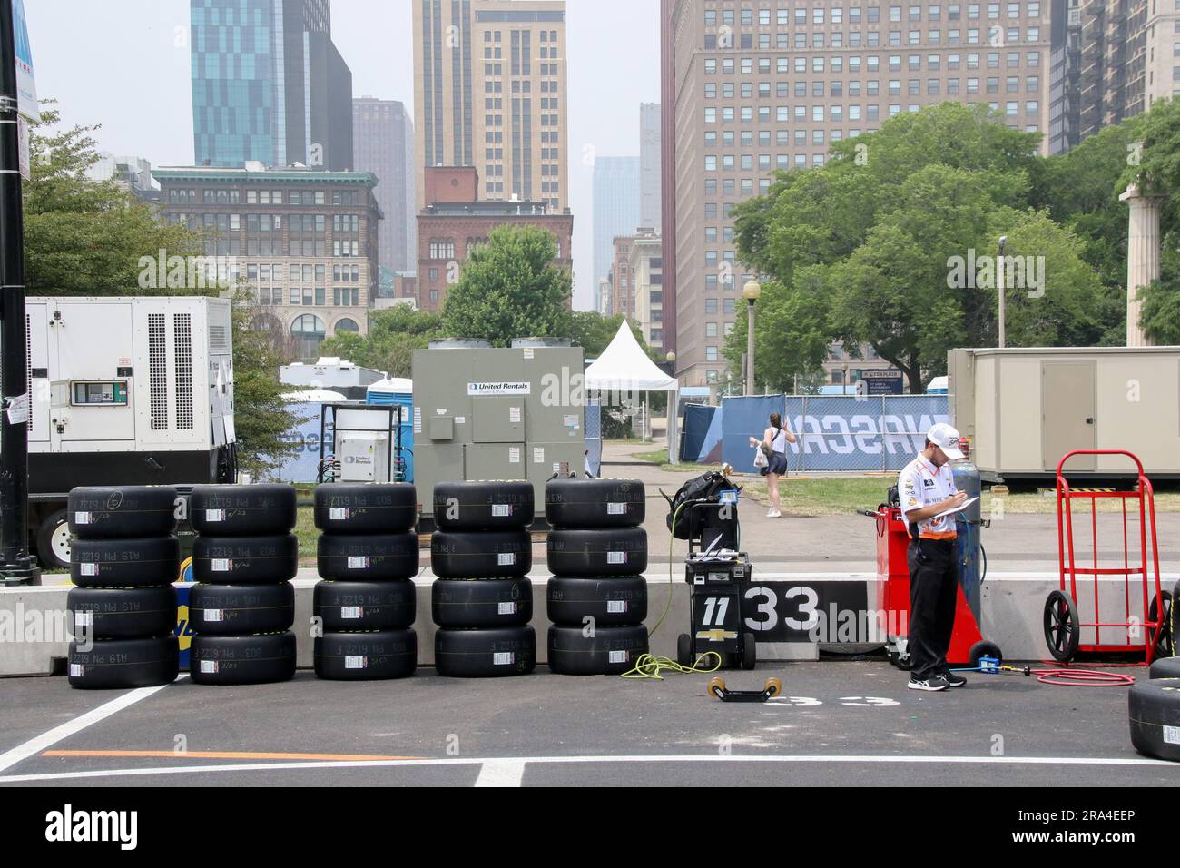 Pit crew workers move tires to prepare them for the the inaugural ...