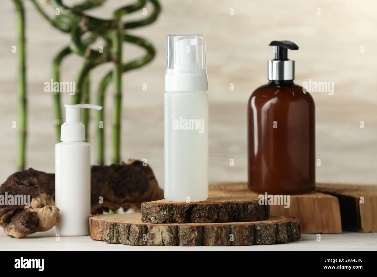 Bottles of face cleansing products on white table Stock Photo - Alamy