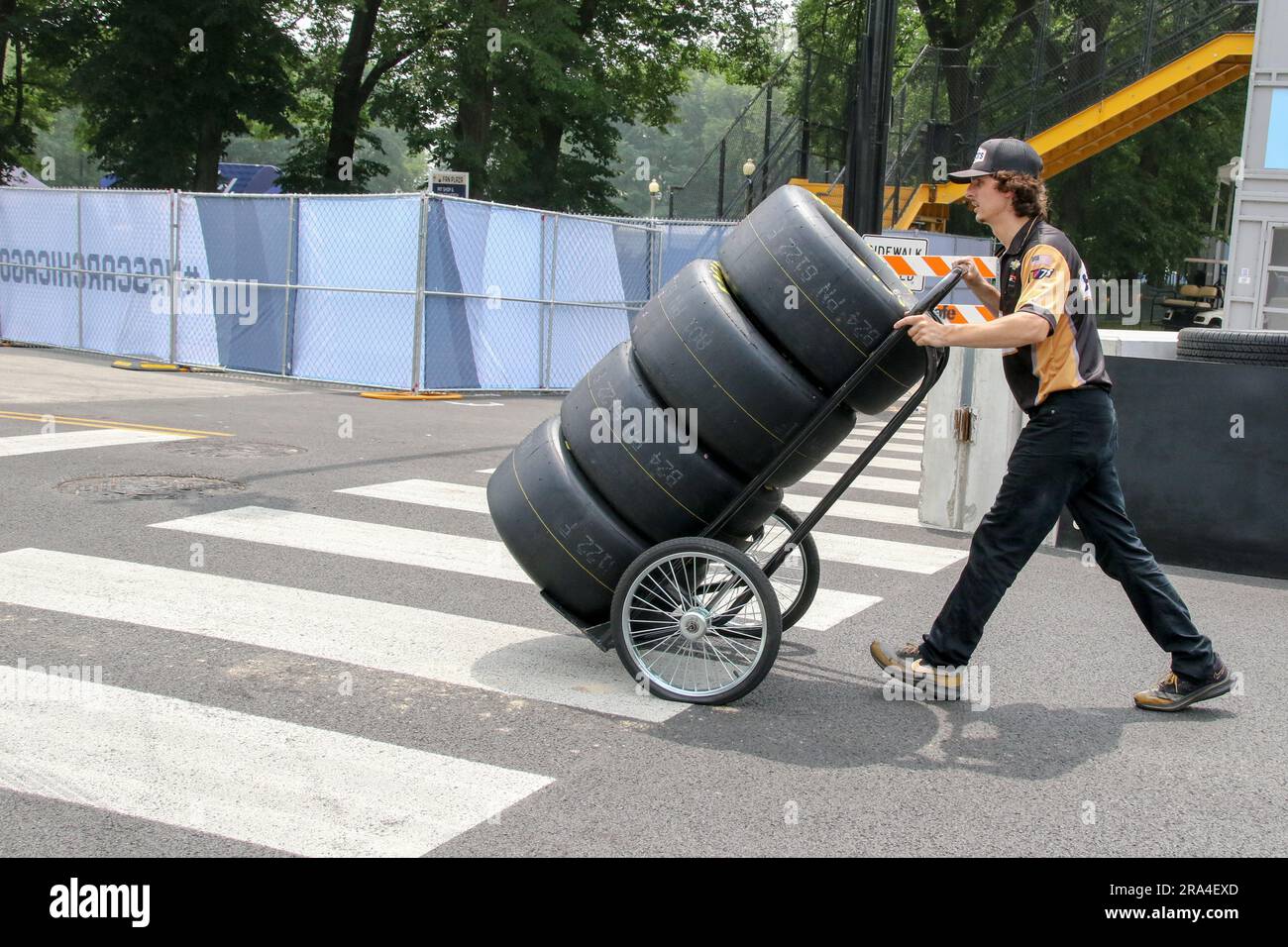 Pit crew workers move tires to prepare them for the inaugural NASCAR ...