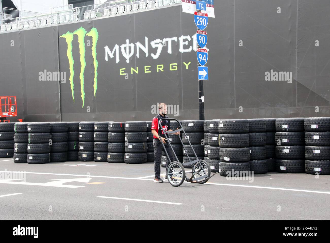 Pit crew workers move tires to prepare them for the the inaugural ...