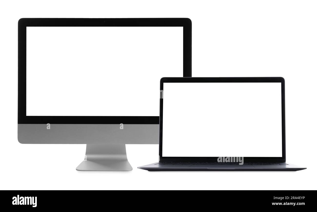 Computer monitor and laptop with blank screens on white background ...