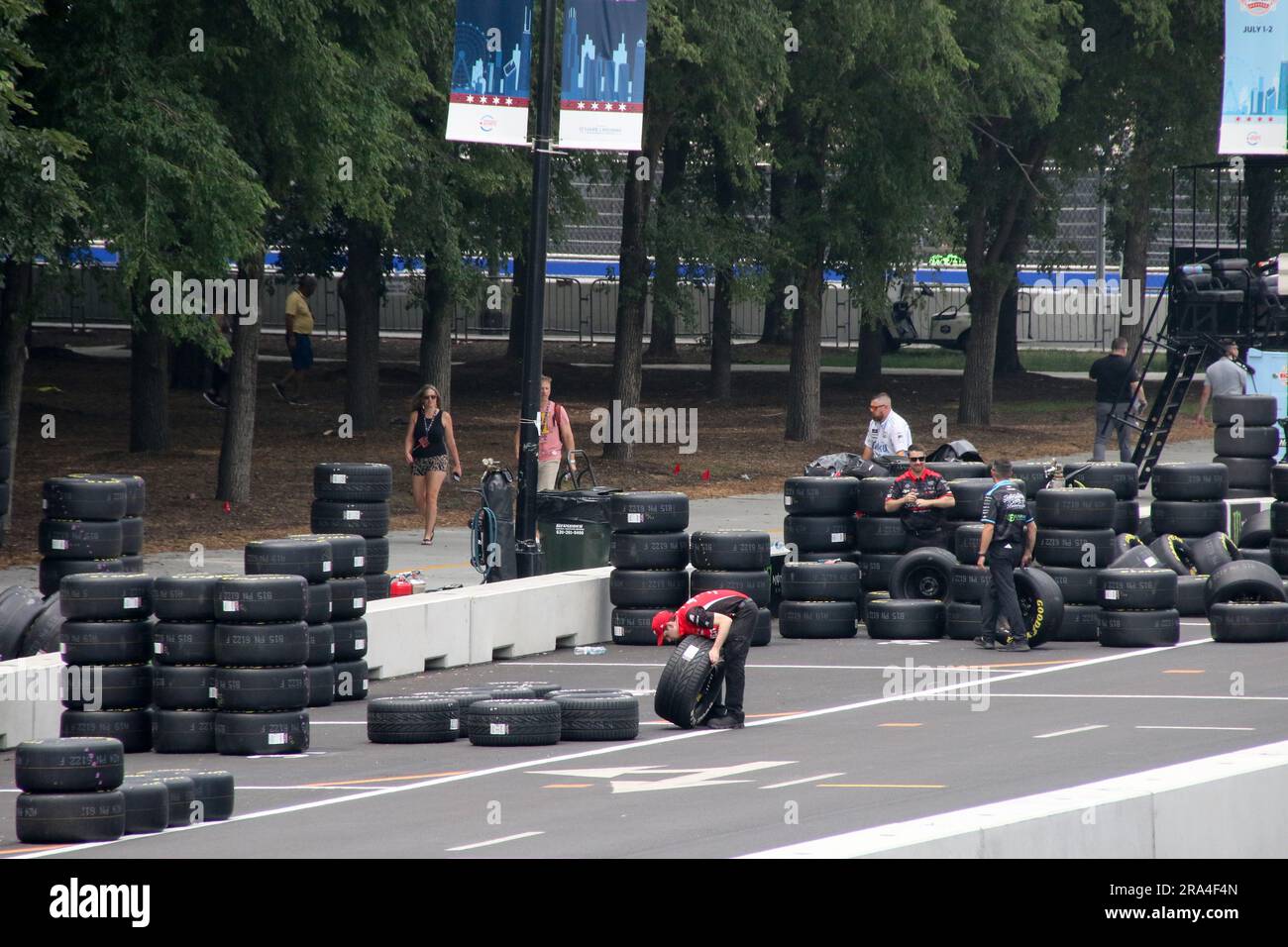 Pit crew workers move tires to prepare them for the the inaugural ...