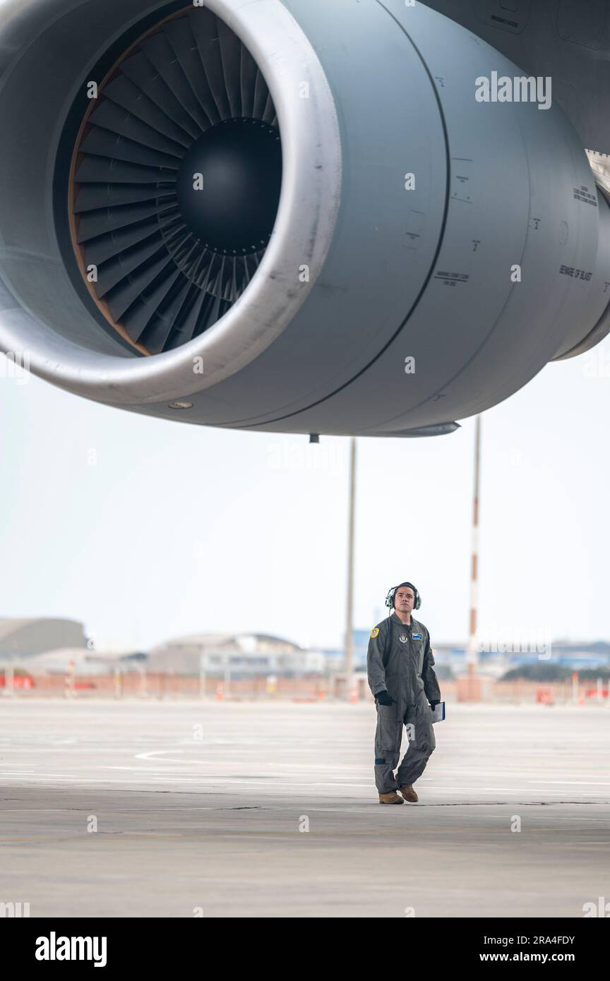 A U.S. Air Force loadmaster inspects the engine of a C-5M Super Galaxy ...