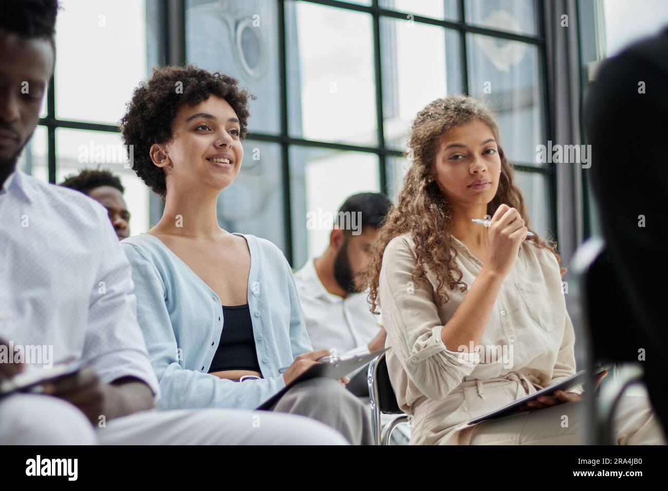 I have a question. Group of business people sitting at the chairs in ...