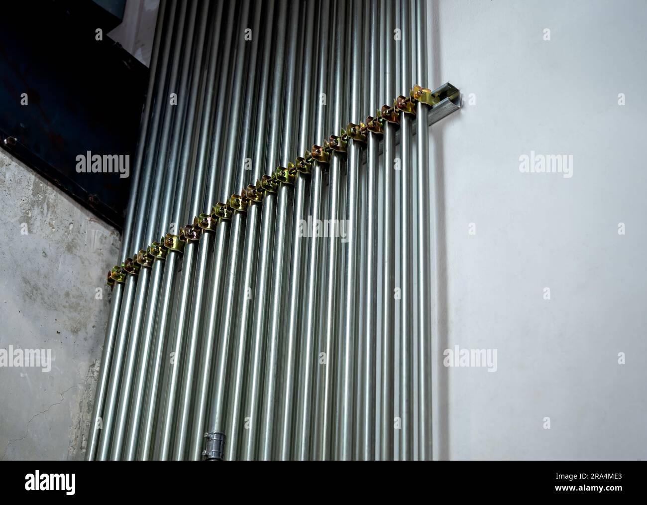 Wiring electric steel pipeline on concrete wall background. Steel tube ...