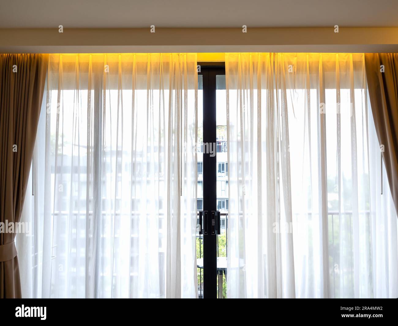 White translucent linen curtain and beige blackout curtains on curtain ...