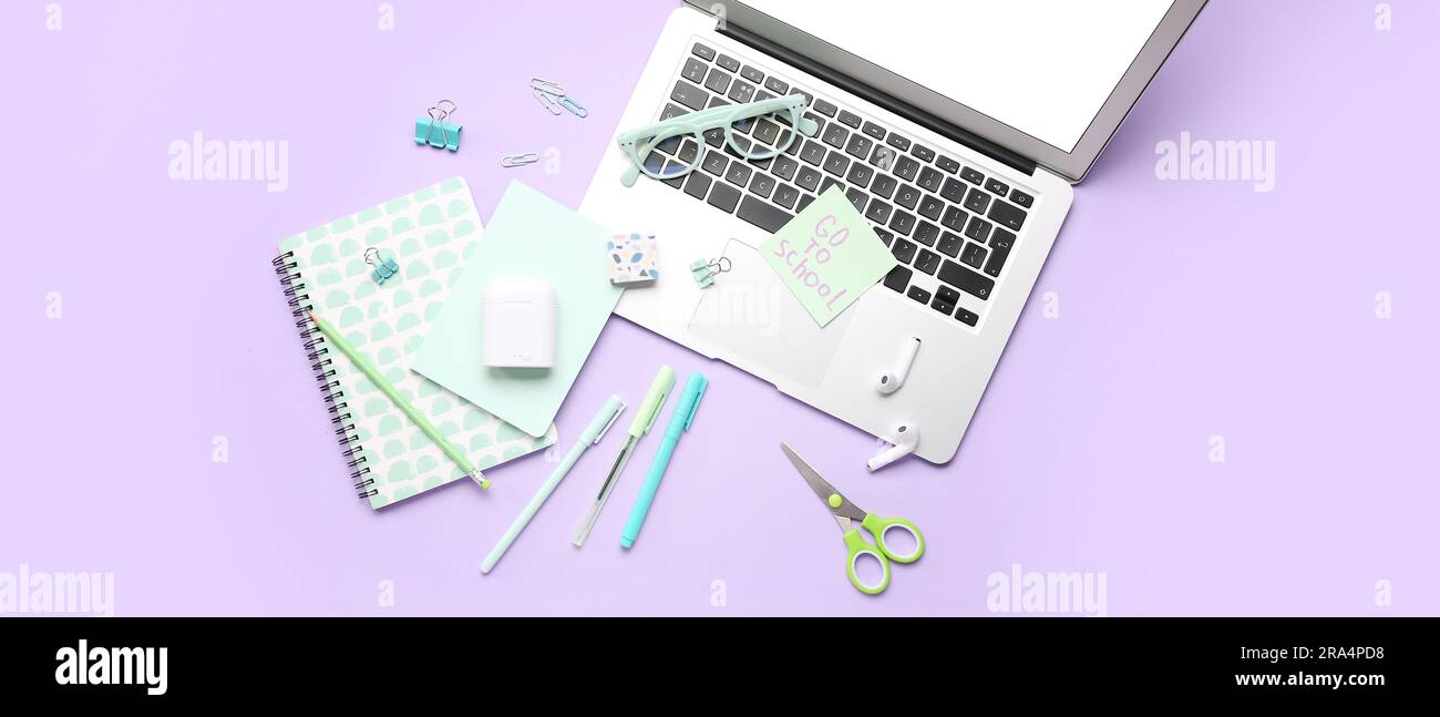Sticky note with text GO TO SCHOOL, different stationery, laptop and ...