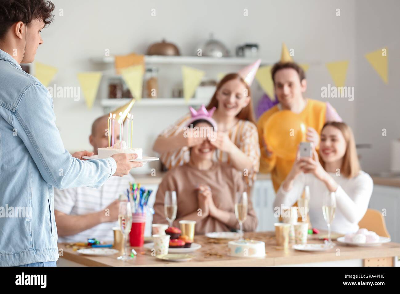 Young man bringing Birthday cake to his friend at party Stock Photo - Alamy