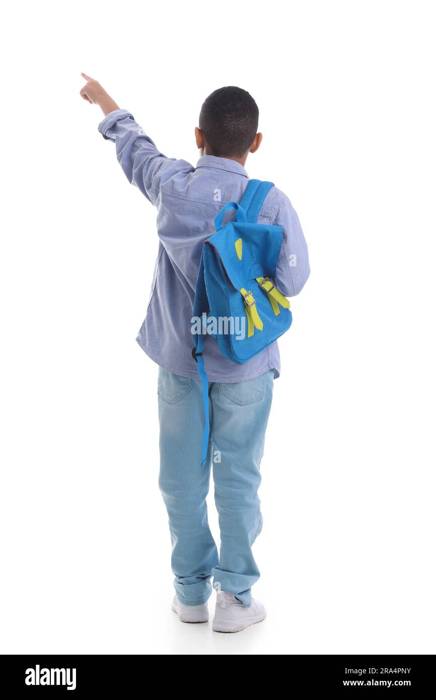 Little African-American schoolboy with backpack pointing at something ...