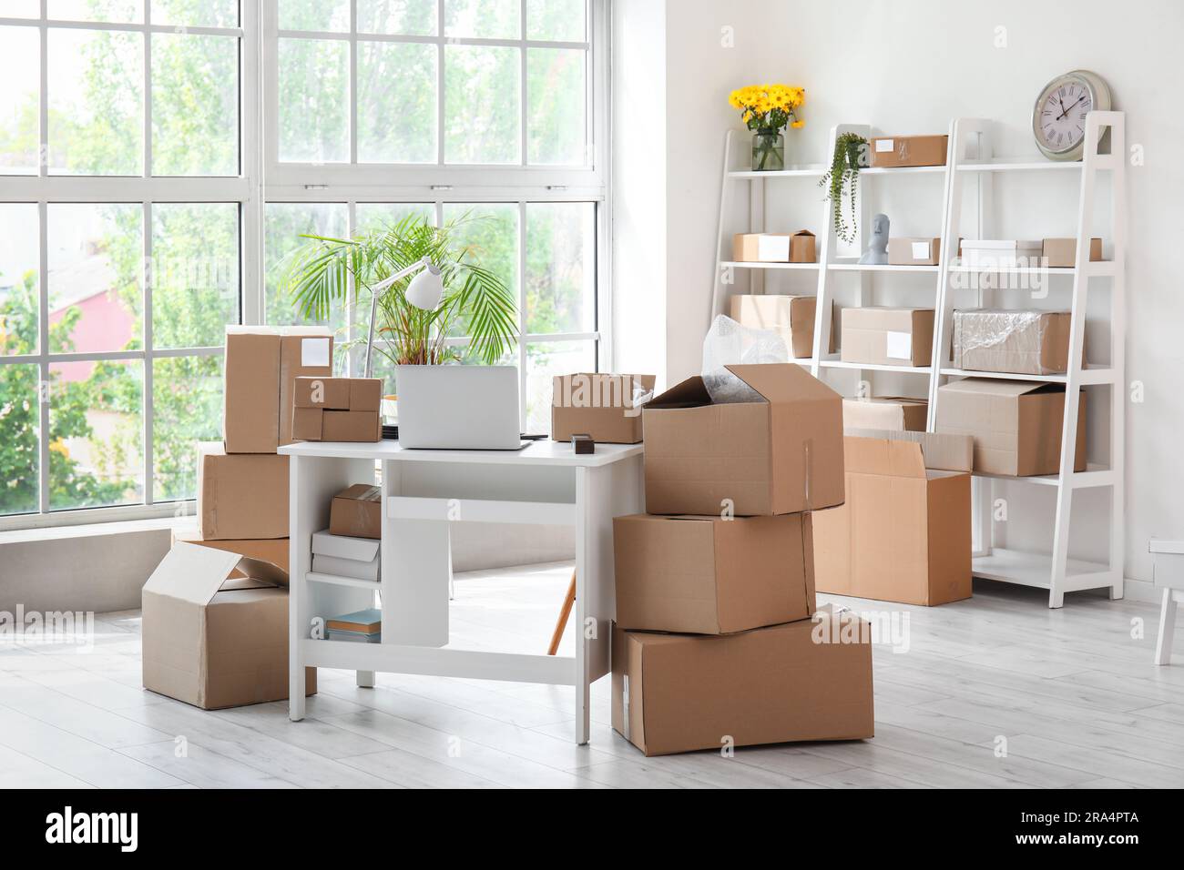 Interior of office with workplace and parcels Stock Photo - Alamy