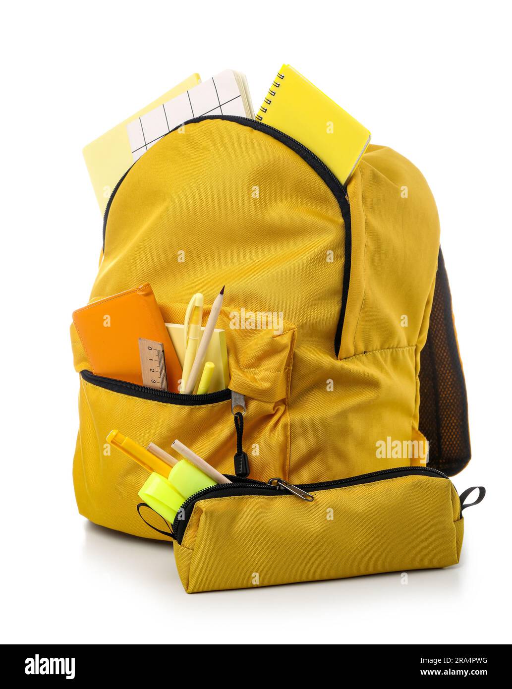 Yellow school backpack with pencil case, notebooks and stationery on ...