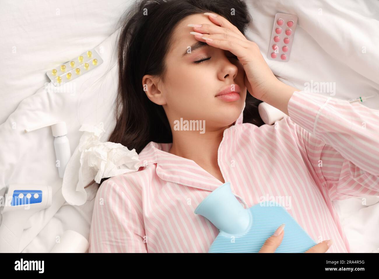 Sick young woman in bed, top view Stock Photo - Alamy