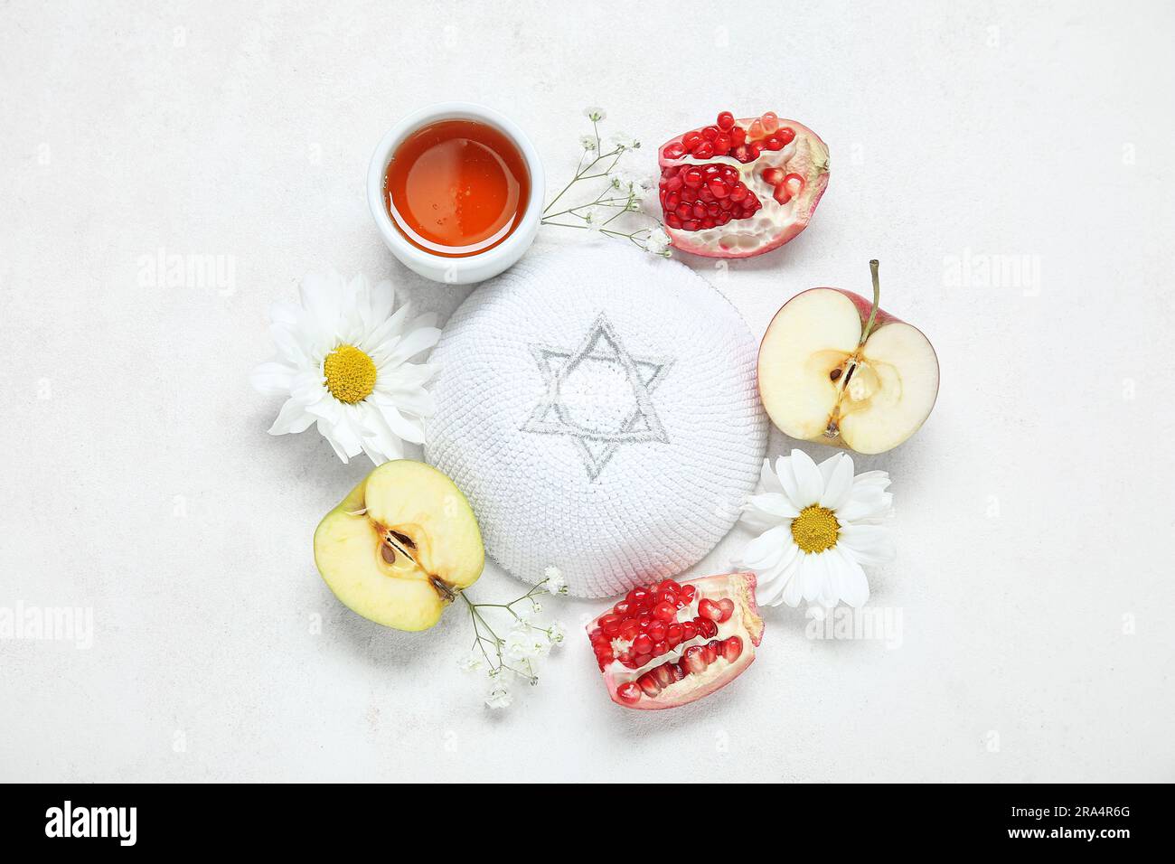 Composition with kippah, ripe fruits, flowers and honey on light ...