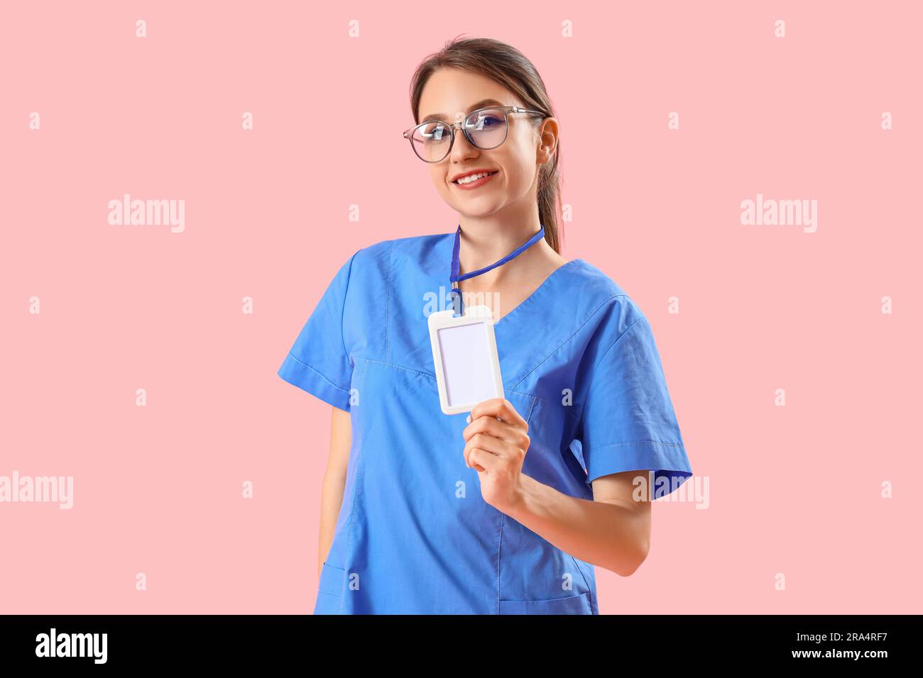 Female medical intern with badge on pink background Stock Photo - Alamy