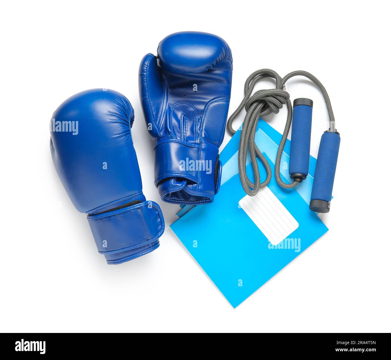 Notebooks with boxing gloves and skipping rope isolated on white ...