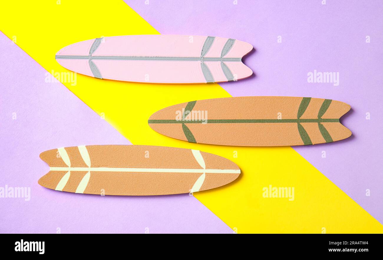 Different mini surfboards on color background Stock Photo - Alamy