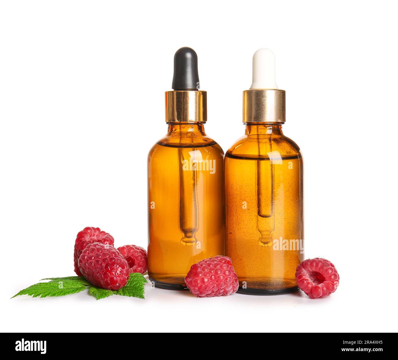 Bottles of cosmetic raspberry oil on white background Stock Photo - Alamy
