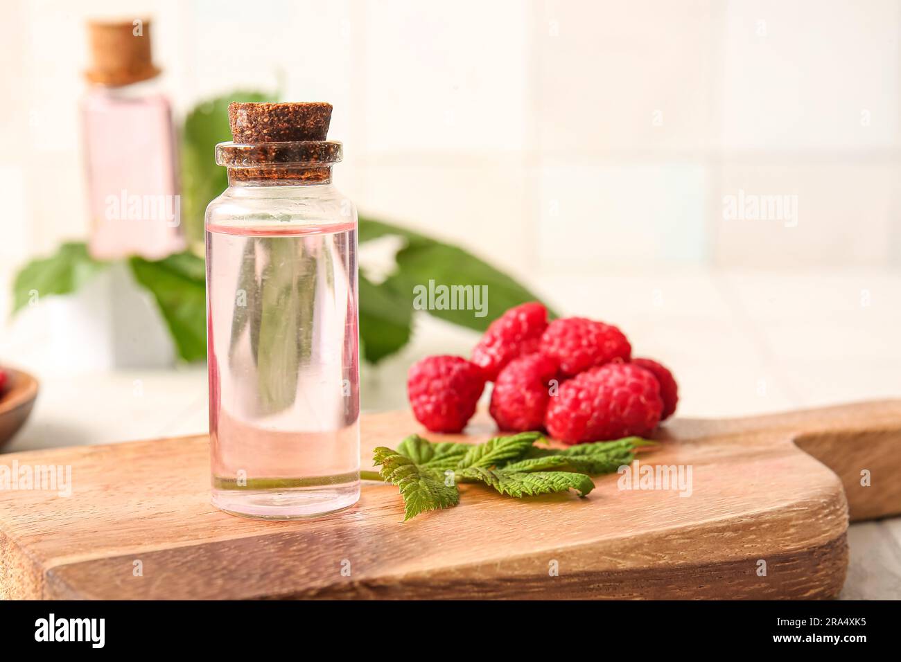 Bottle of cosmetic raspberry oil on white background, closeup Stock ...