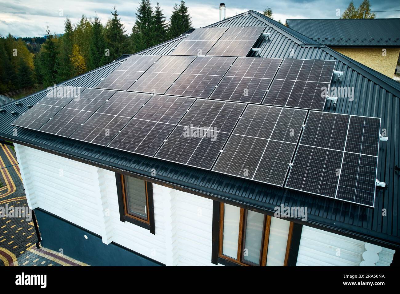 Aerial view of new modern house cottage with solar photovoltaic panel ...