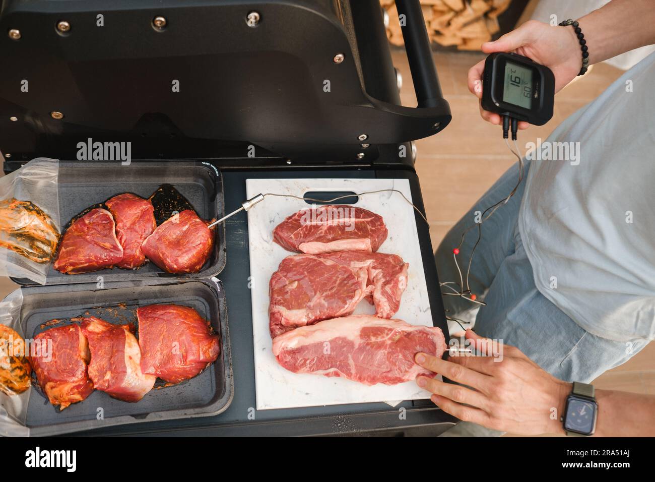 Preparation for Cooking meat on an open grill with temperature check ...