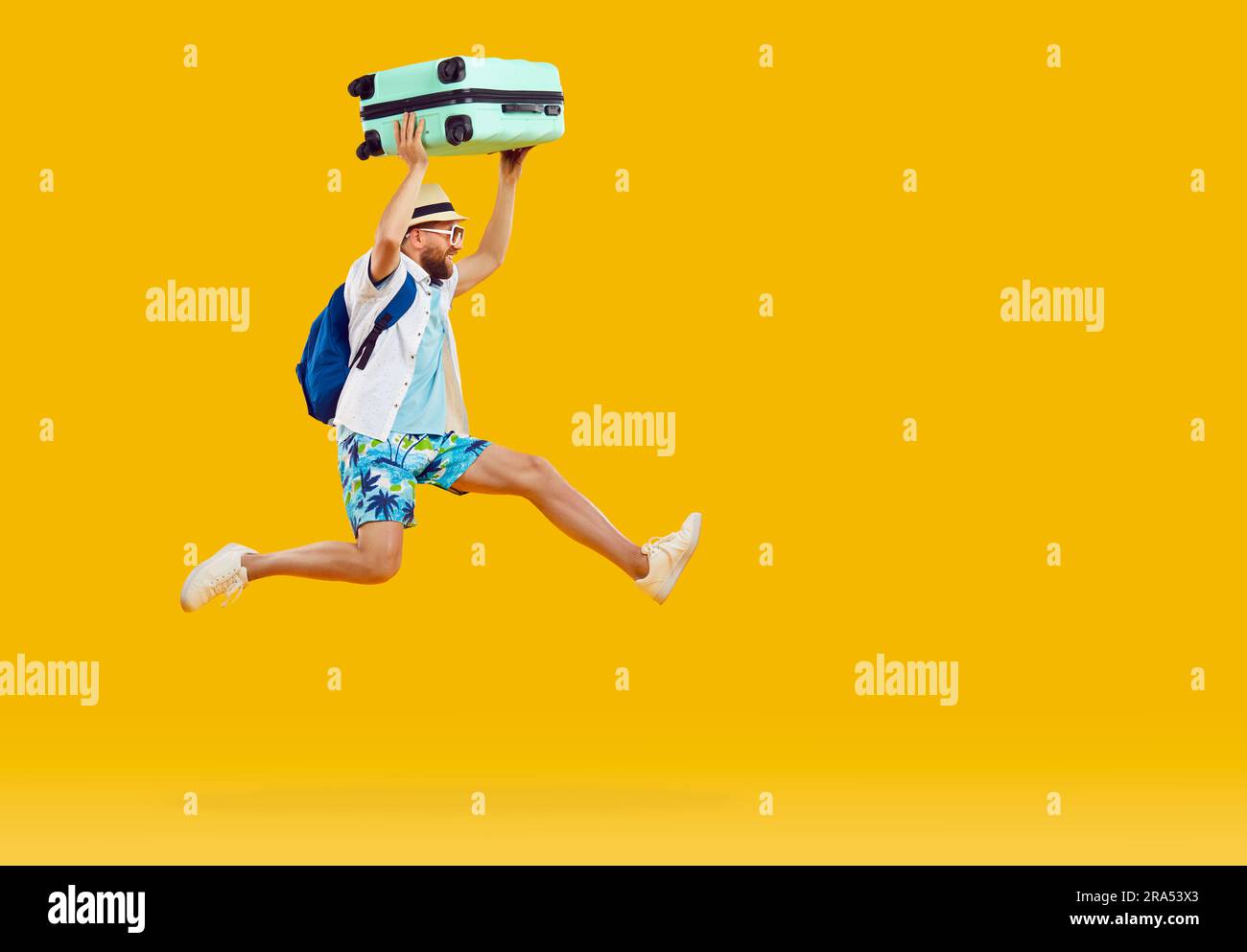 Tourist in with holiday suitcase and backpack running and jumping on ...