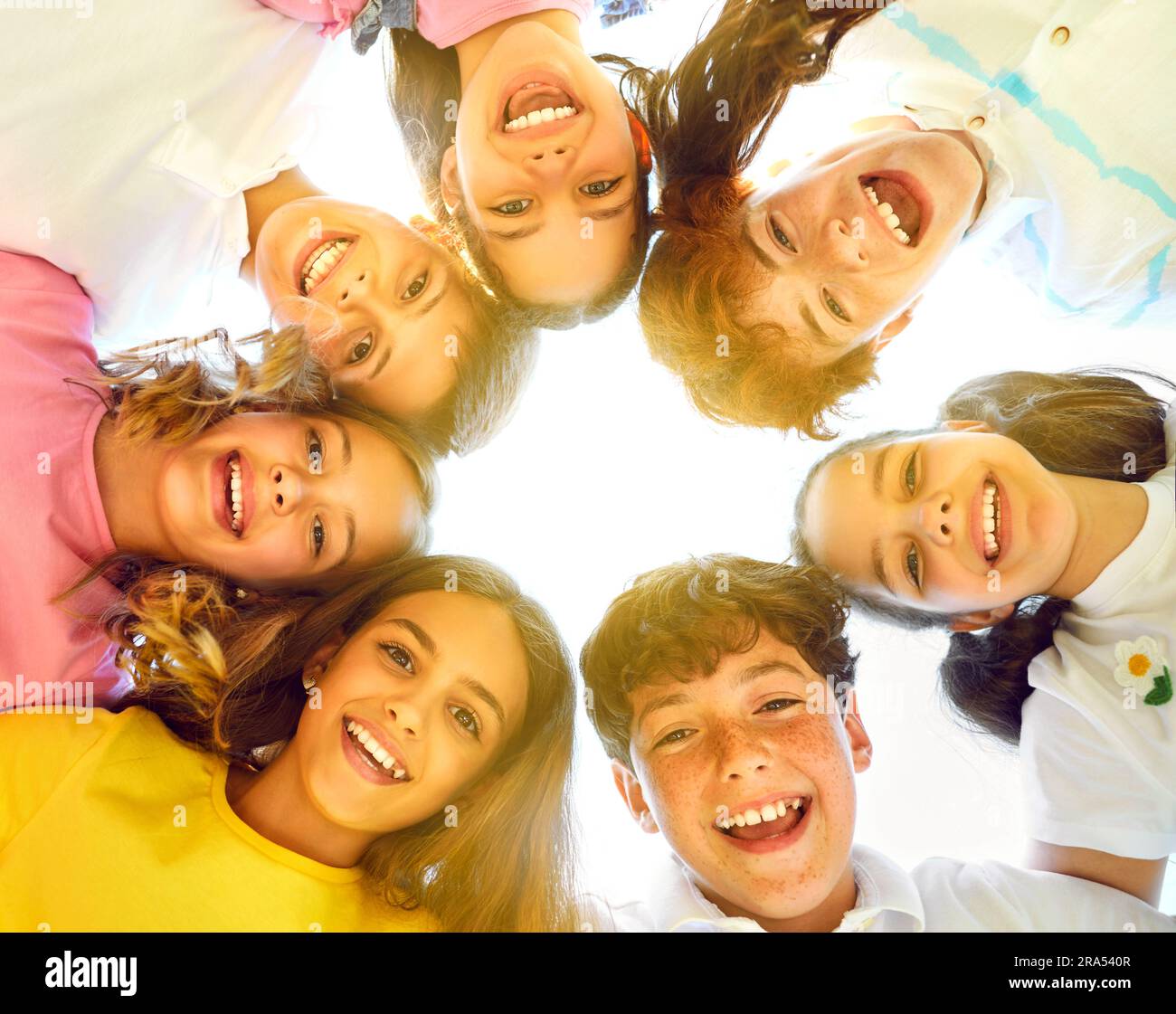 Group of happy, cheerful little kid friends playing together, huddling ...