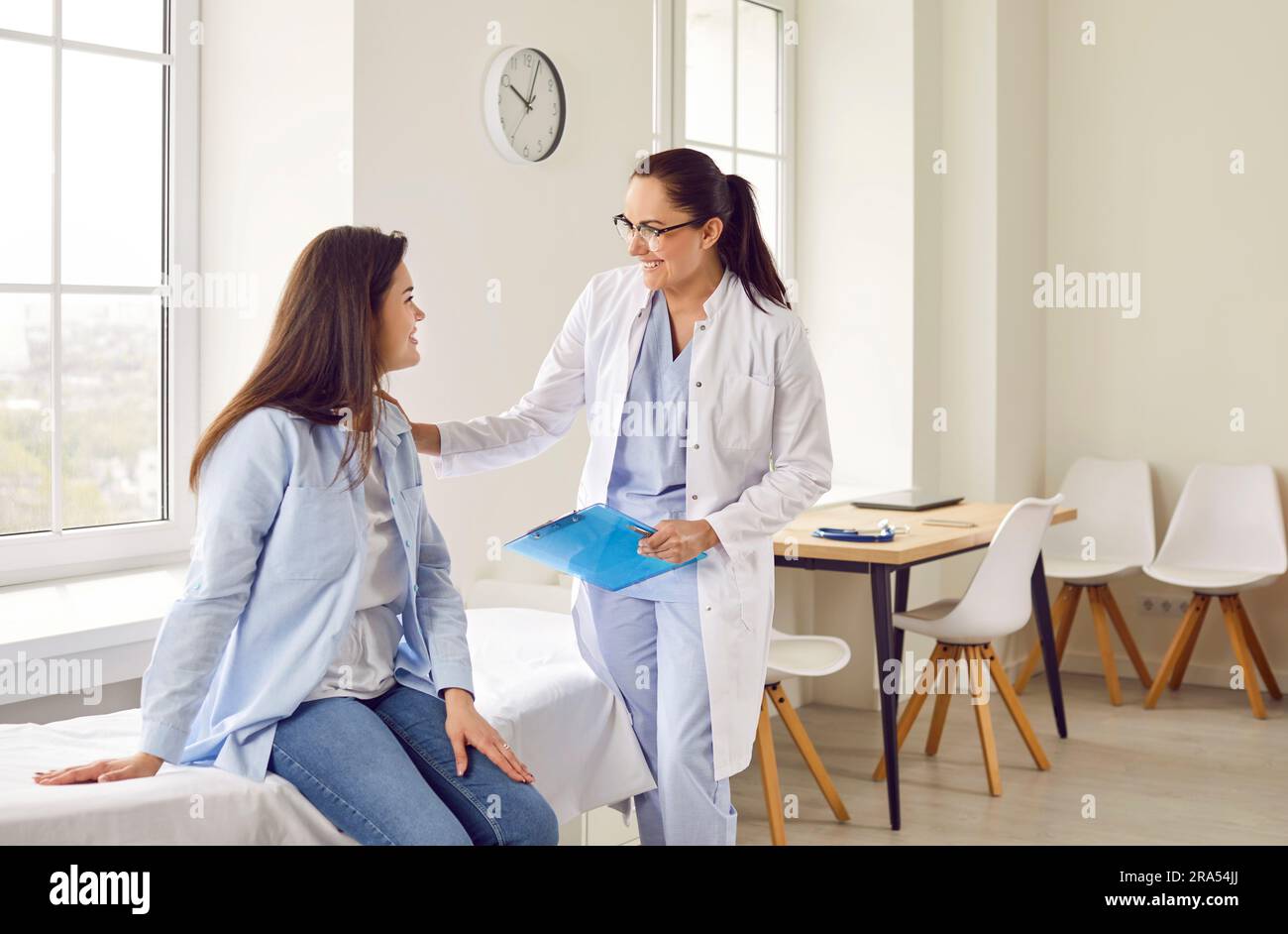 Happy pregnant woman talking with her gynecologist doctor during ...