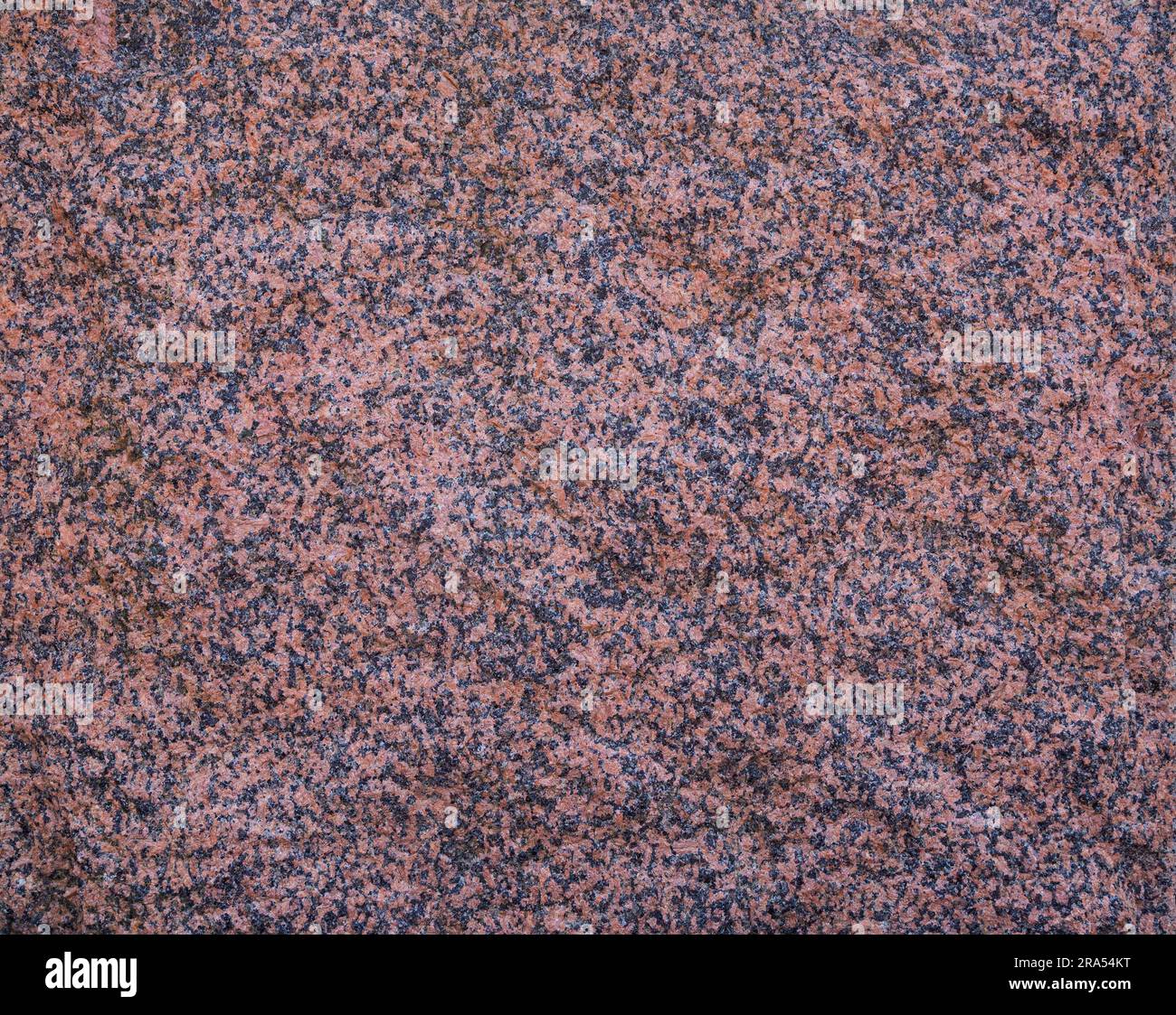 Close-up of natural red granite rock surface texture, front view ...