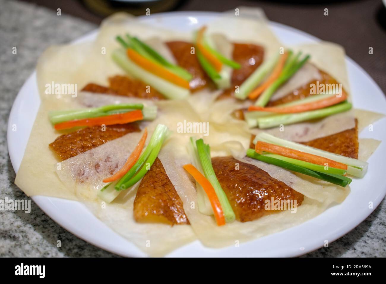 Deep fried Peking duck skin, served on plate Stock Photo - Alamy