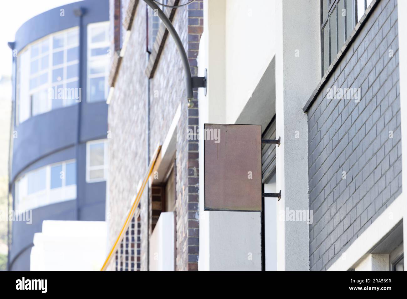 Blank sign fixed to building wall with copy space Stock Photo - Alamy