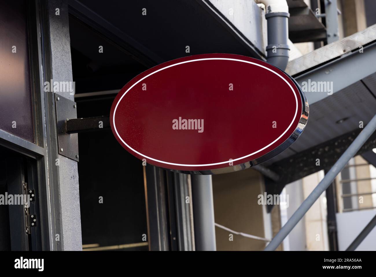 Blank oval sign fixed to building wall with copy space Stock Photo - Alamy