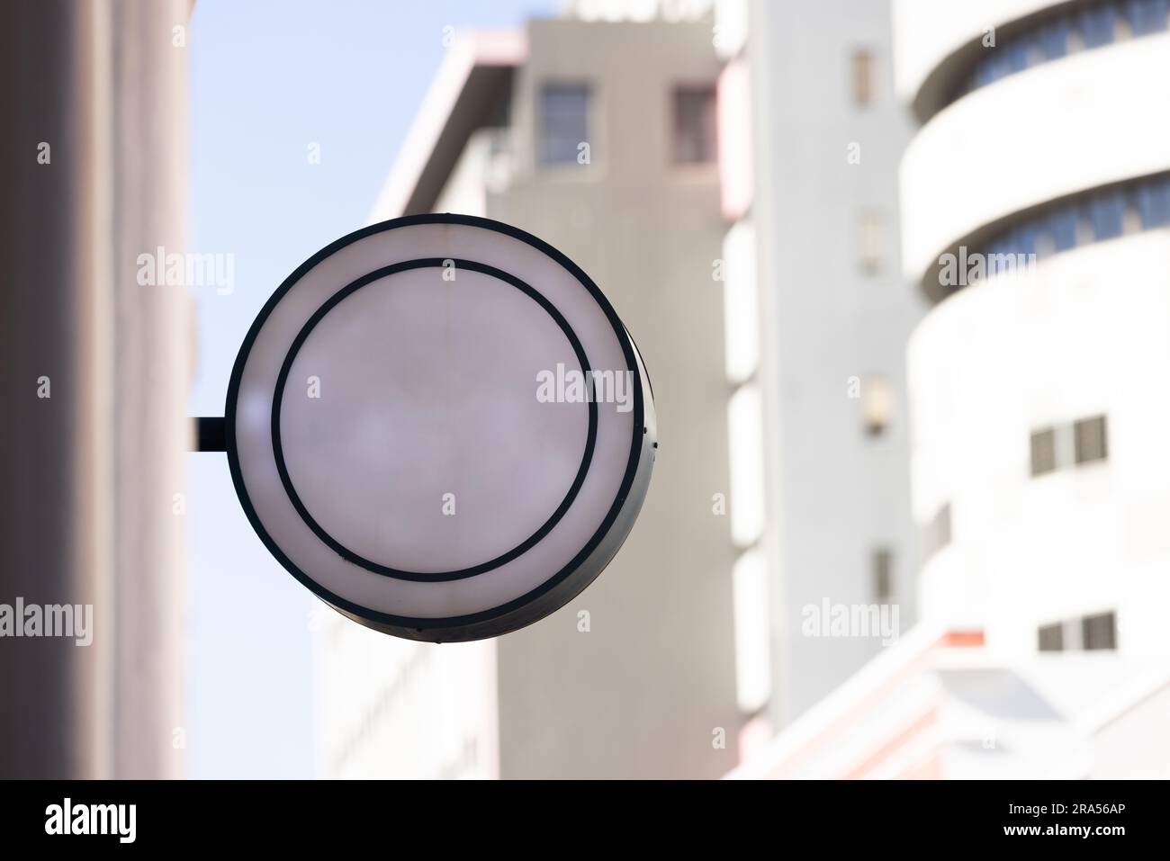 Blank round sign fixed to building wall with copy space Stock Photo - Alamy