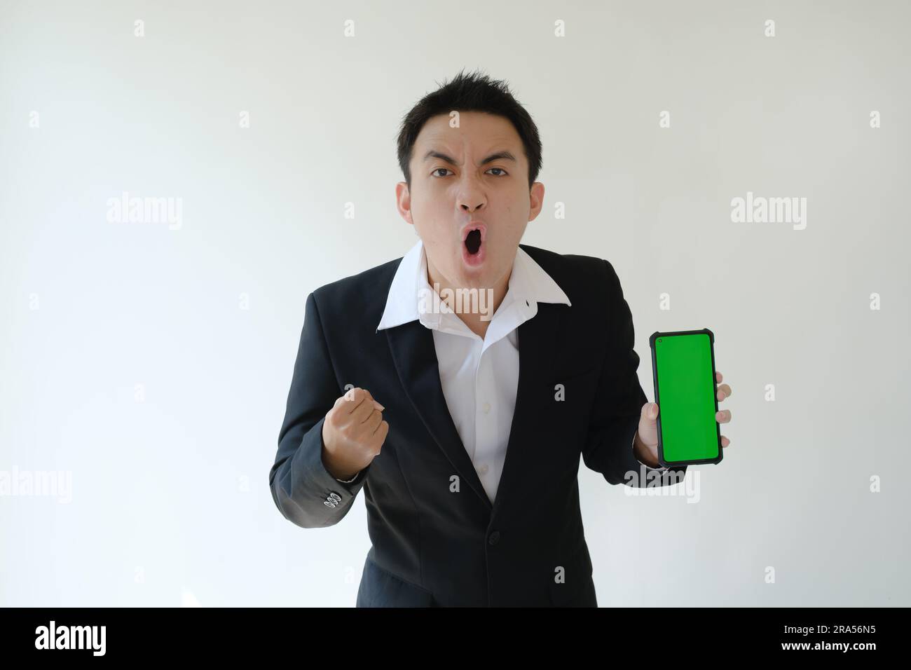 Young Asian business man with happy and excited face expression holding ...