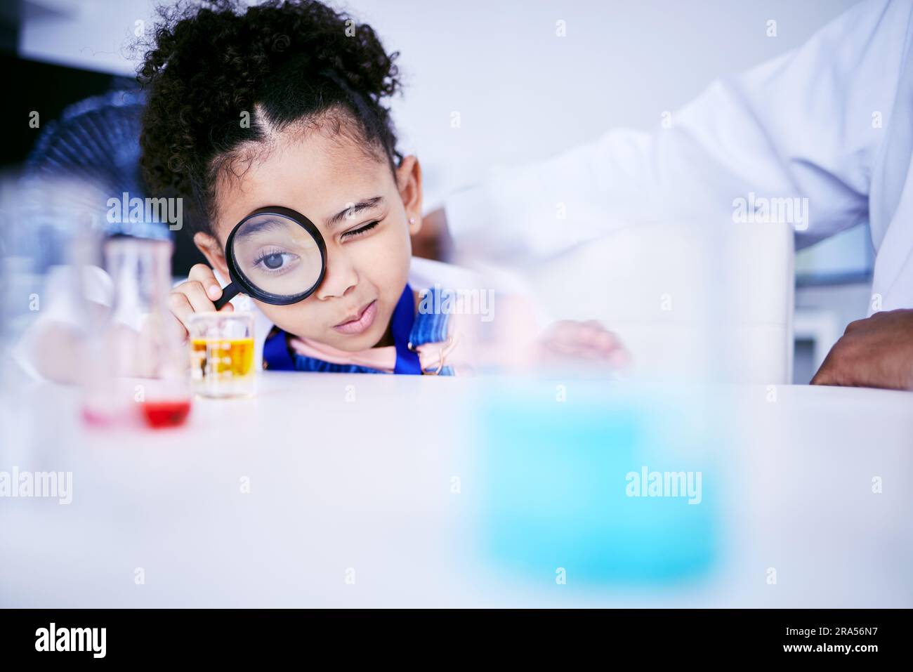 Child, science and chemistry with a magnifying glass in laboratory for ...