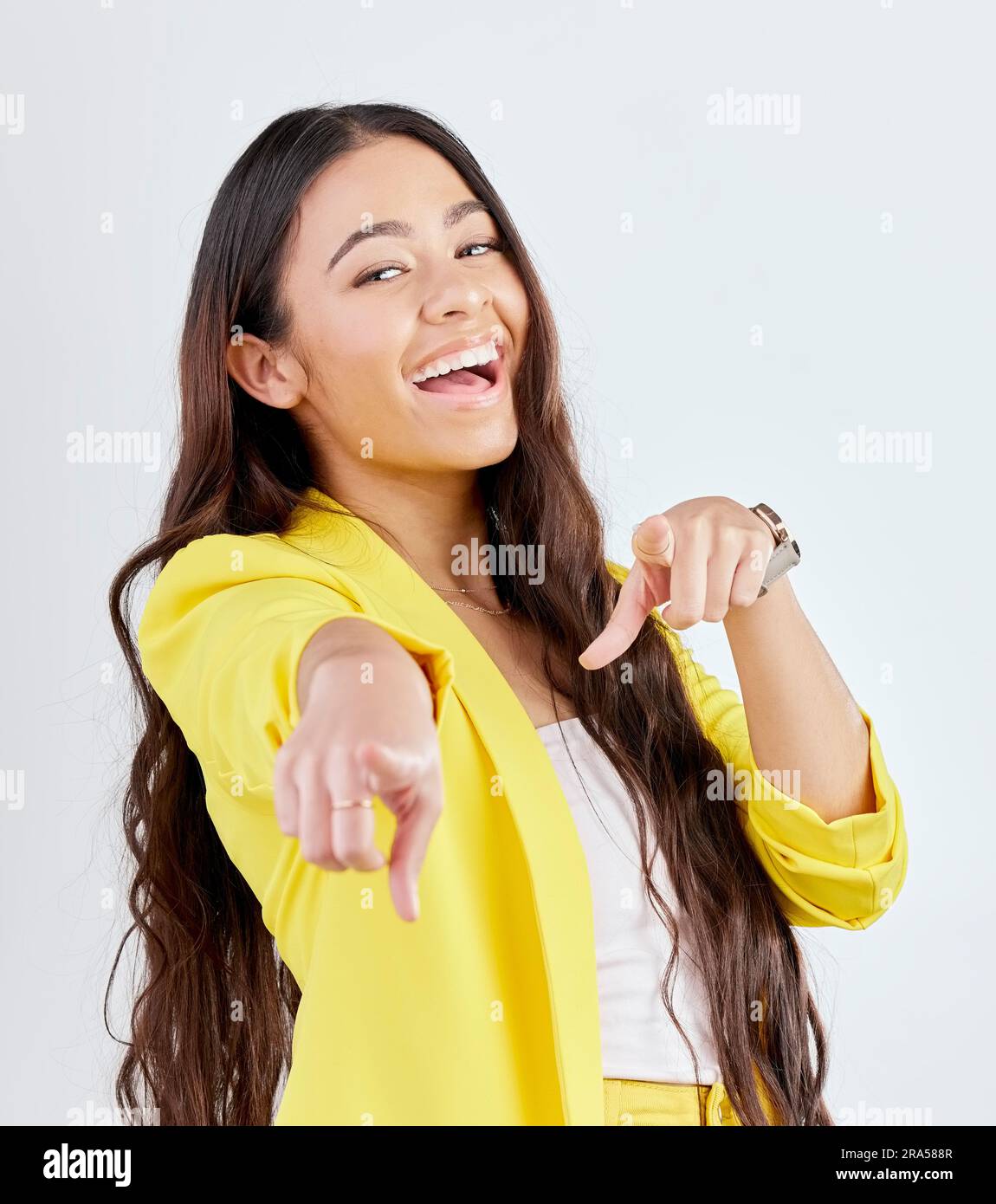 Portrait, pointing and decision with an excited woman in studio on a ...