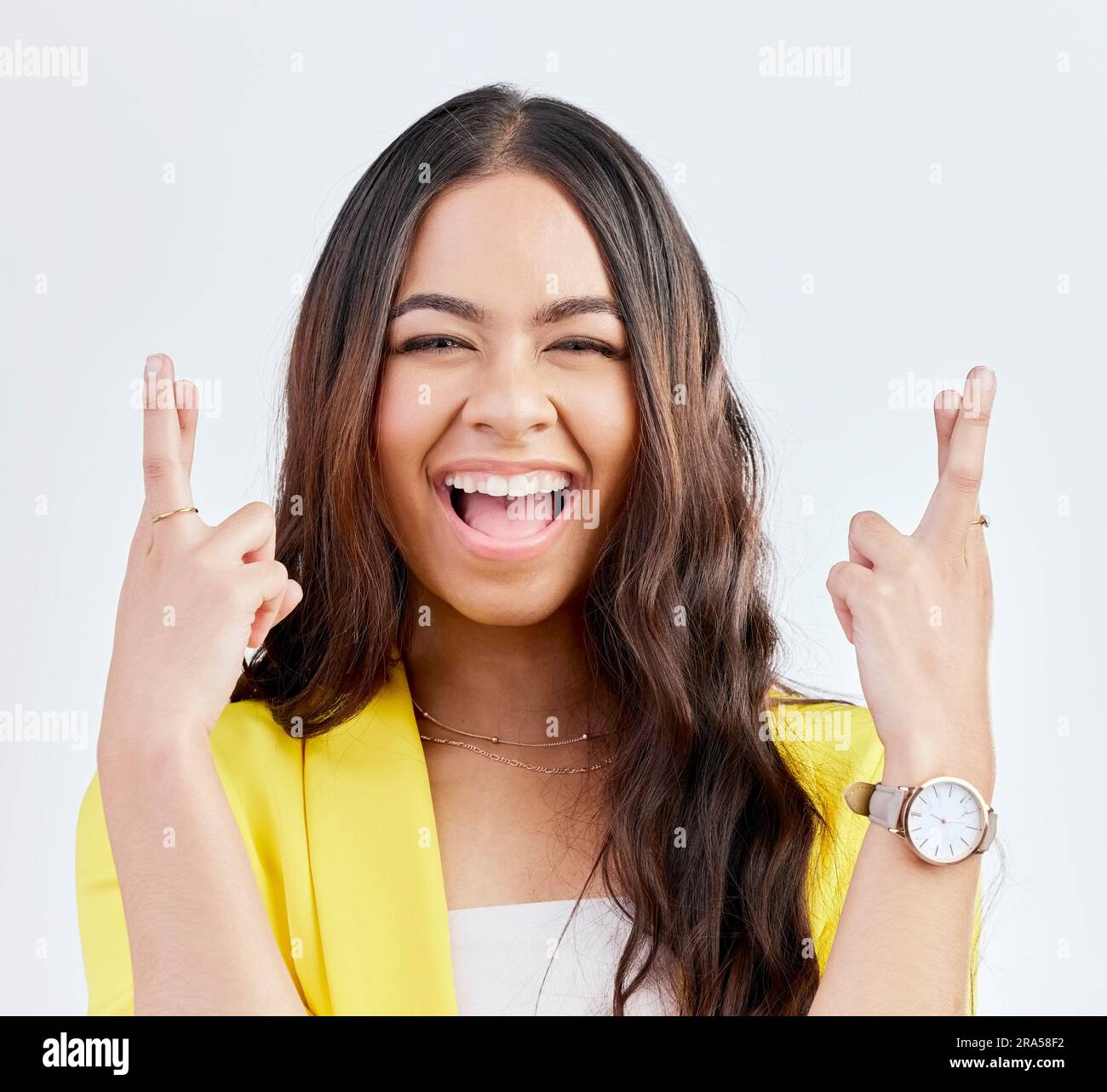 Wish, fingers crossed and portrait of woman in studio with hand gesture ...