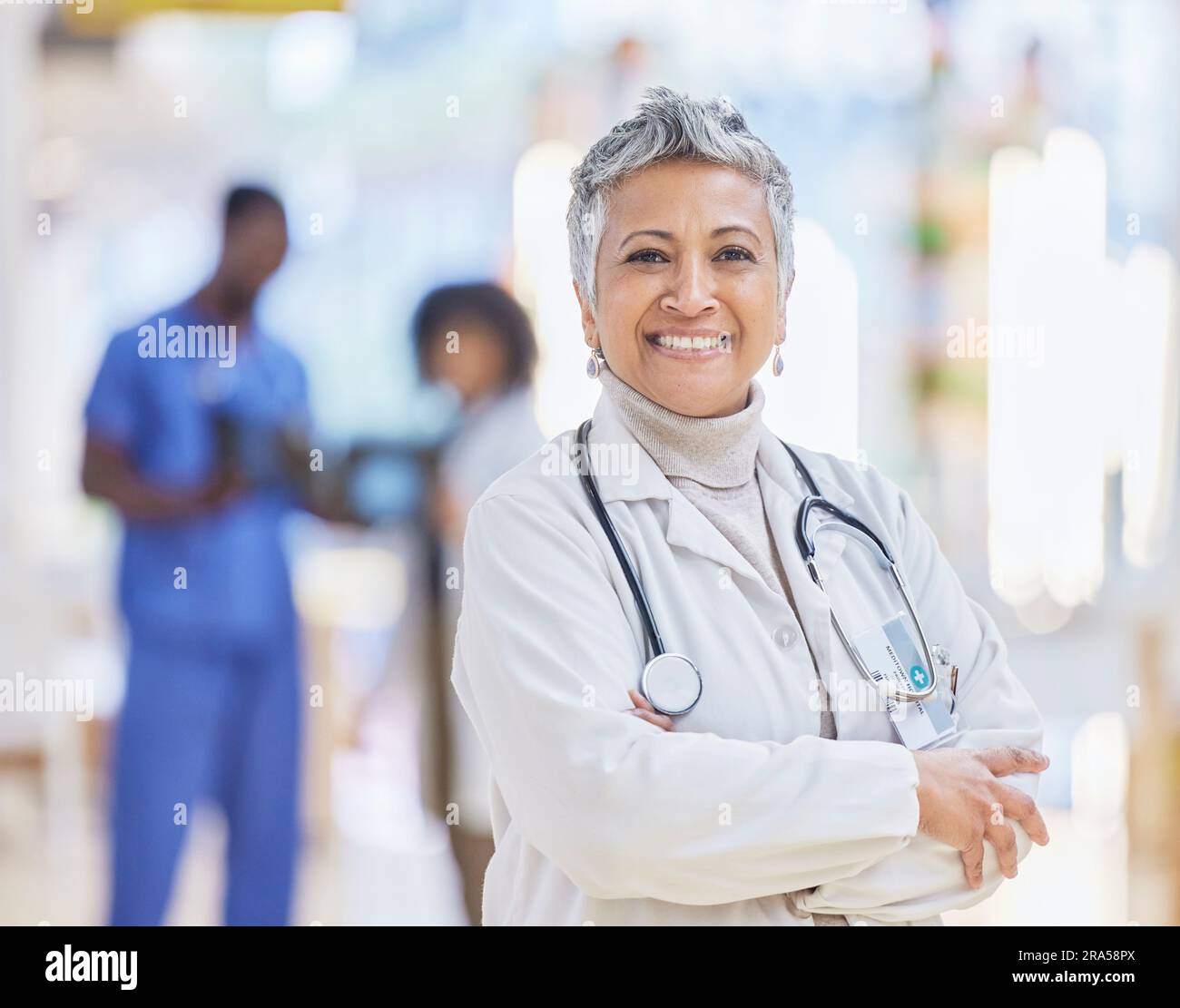 Doctor, portrait and senior woman with arms crossed in hospital for healthcare, wellness and ...