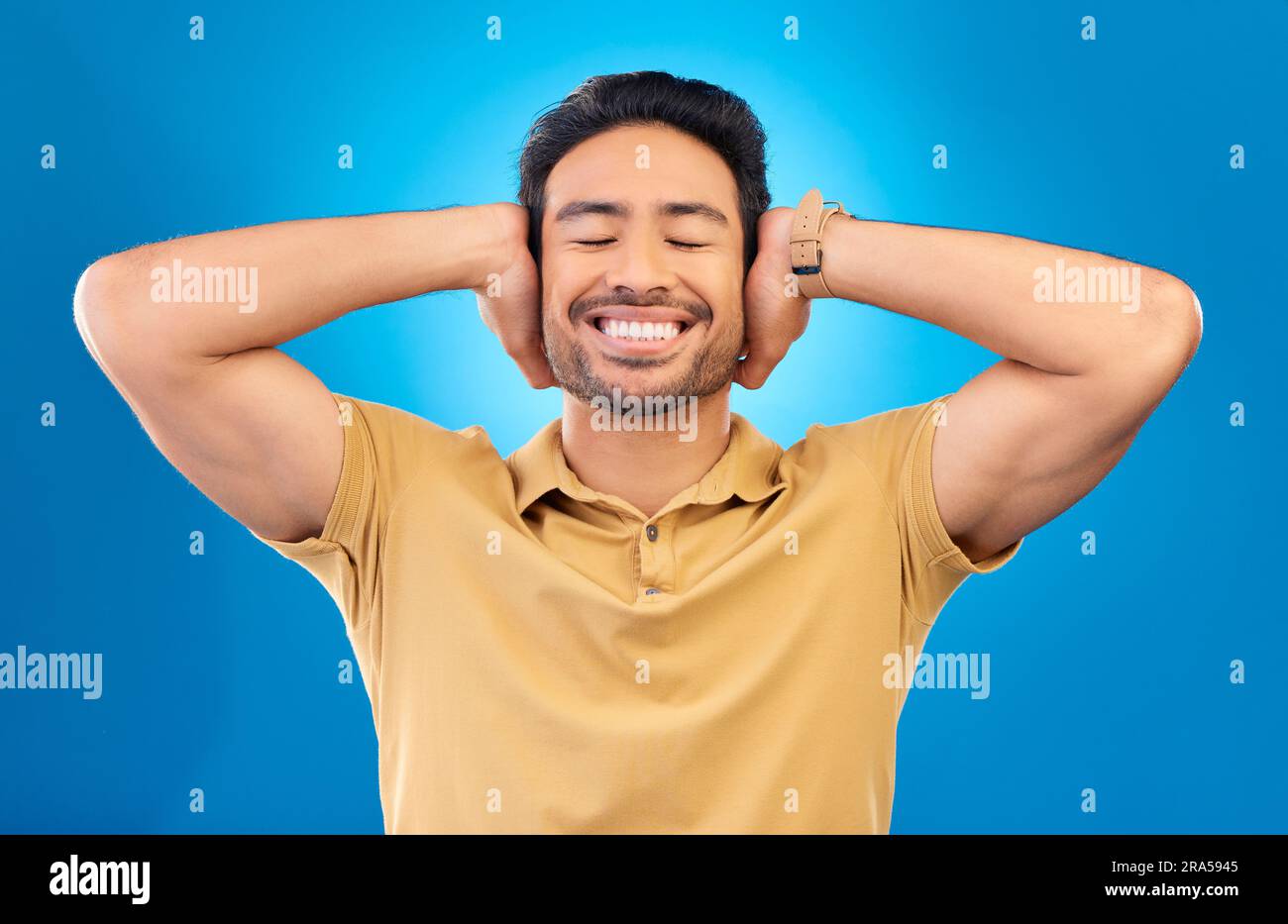 Sound, silence and man cover ears, noise and happiness against a blue ...