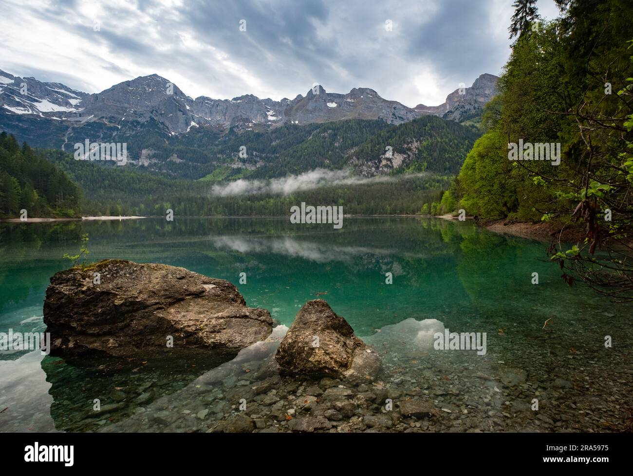 Lake Tovel in the Dolemites during a cloudy morning. Italy Travel ...