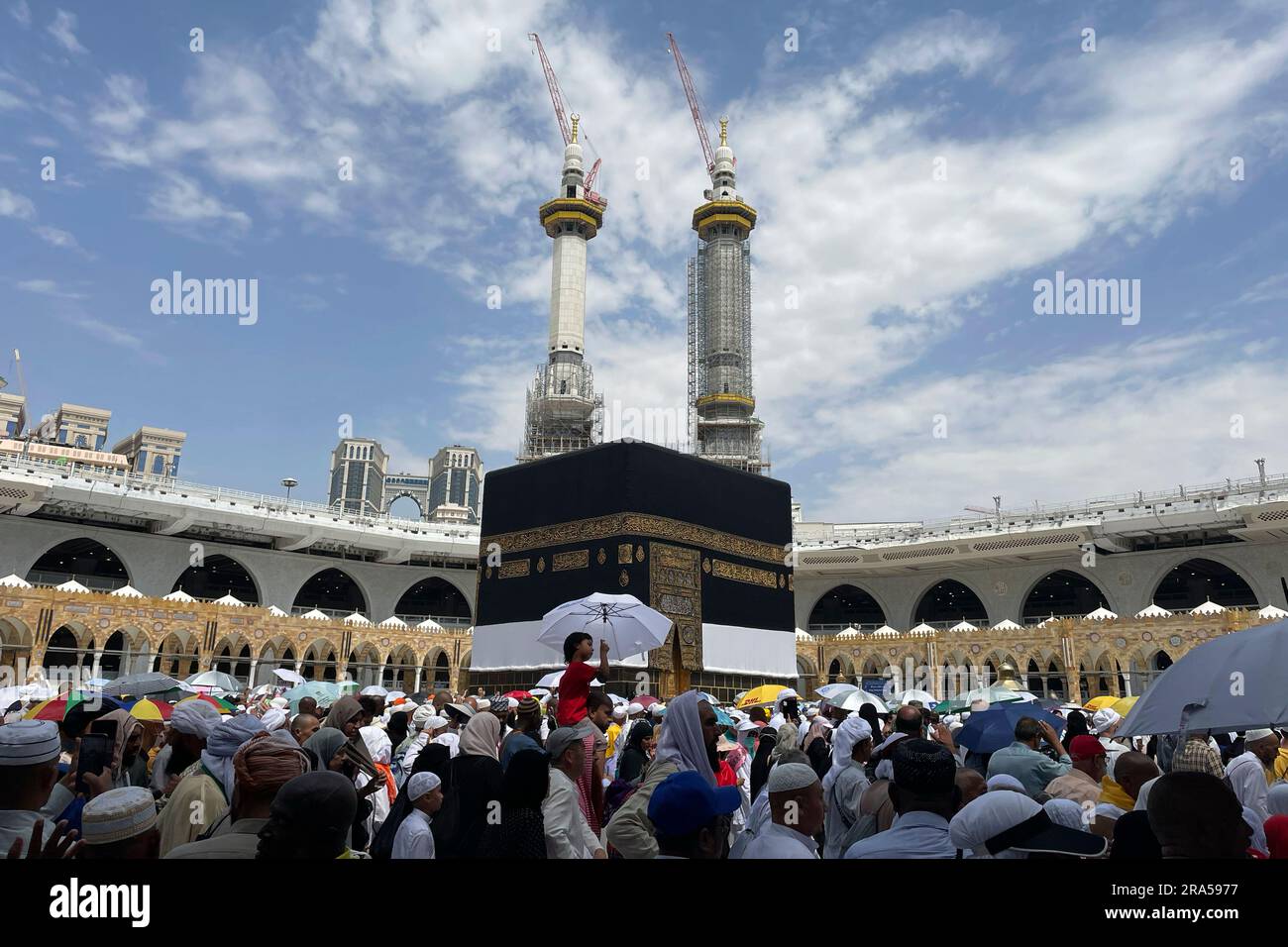 Muslim pilgrims circumambulate the Kaaba, the cubic building at the ...