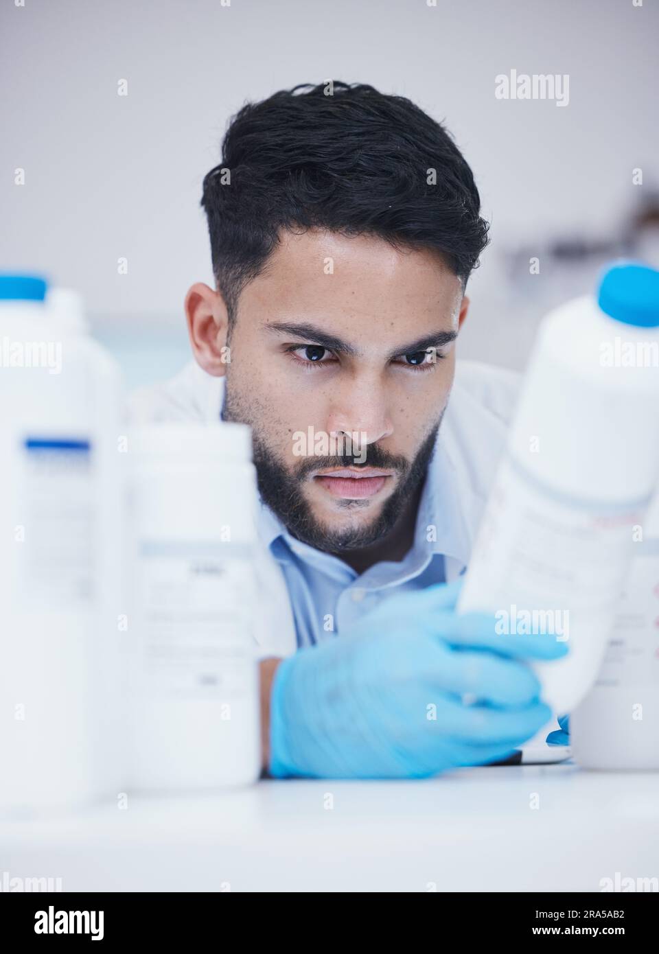Laboratory, man or scientist reading container to check medical stock ...