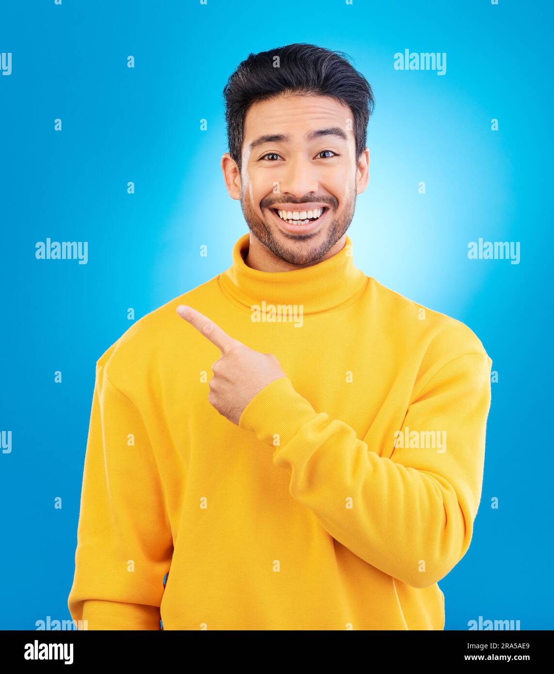 Man, point and smile in studio portrait with choice, fashion and ...