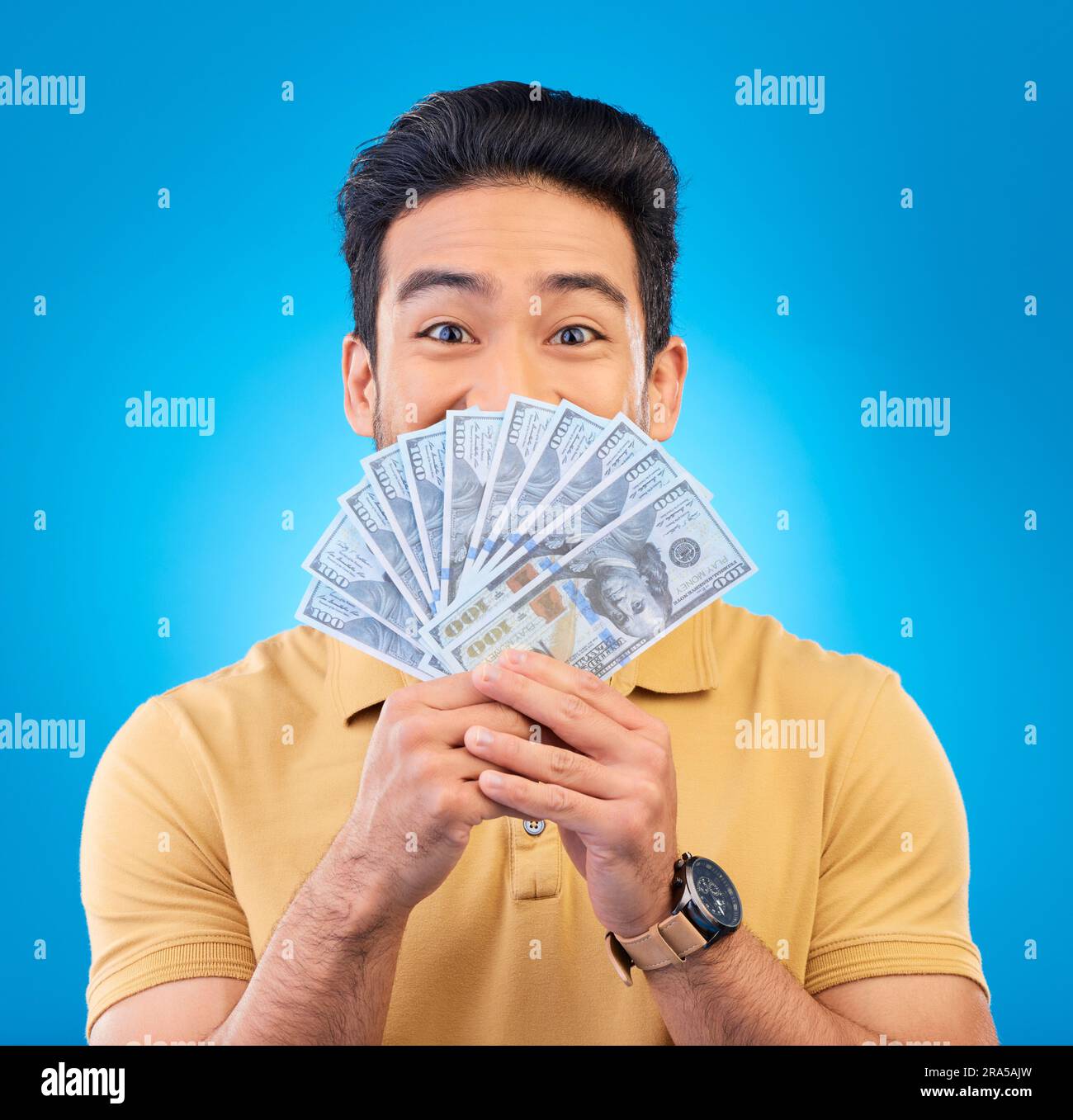 Cash, fan and man with wow face isolated on blue, studio background for ...