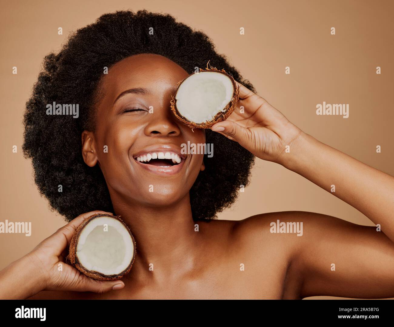 Happy, glow and black woman with coconut for skincare, dermatology ...