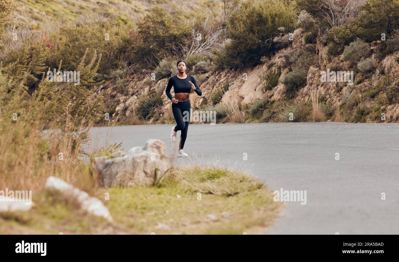 Fitness, running and road with black woman in nature for health, workout and challenge ...