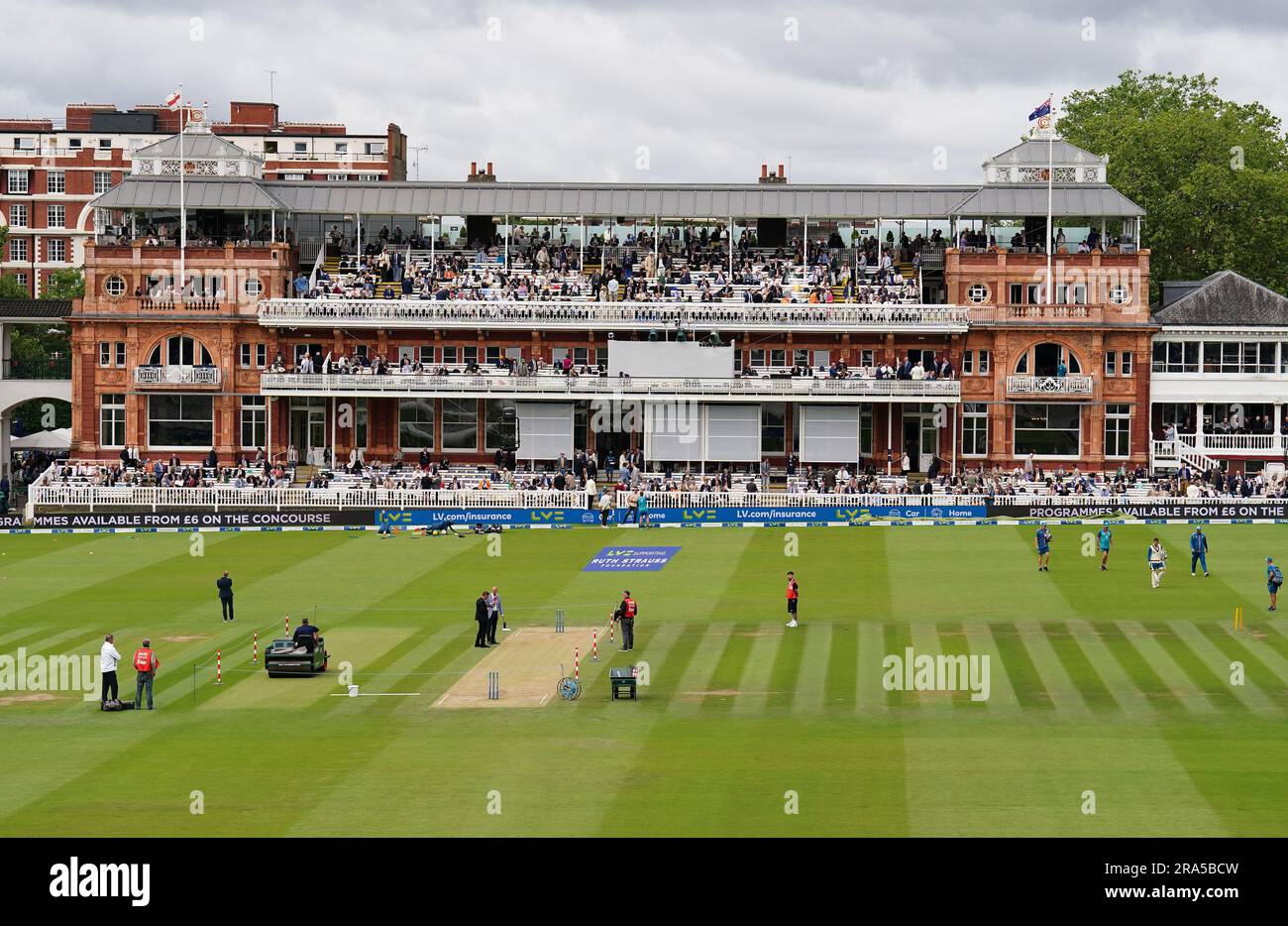 Ground staff prepare the pitch on day four of the second Ashes test ...