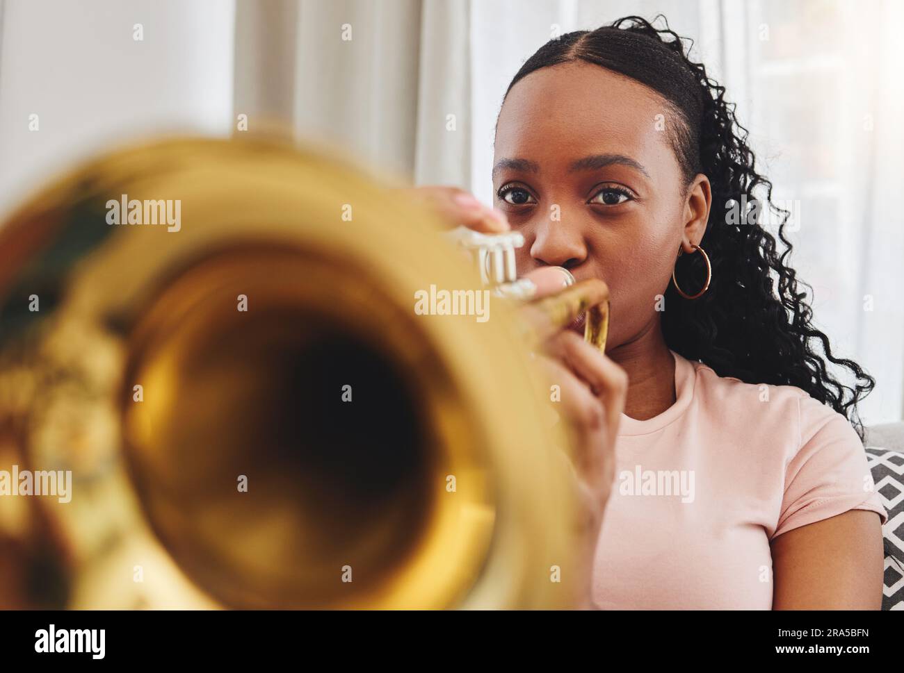 Music, art and woman in home with trumpet, performance and band ...