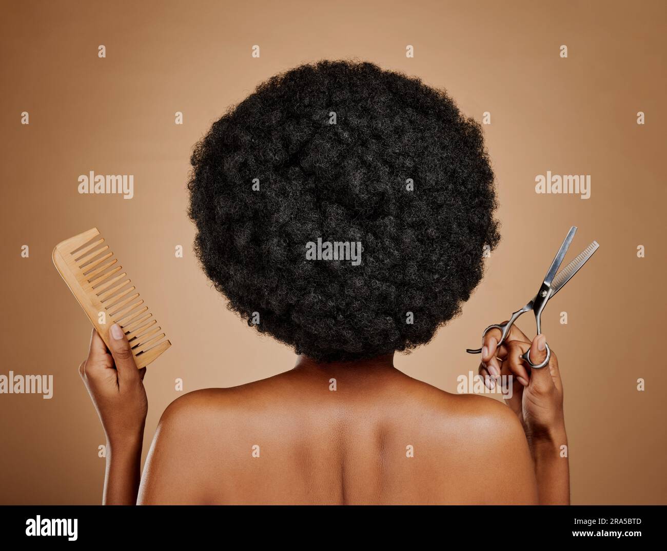 Back, comb and scissors with a black woman in studio on a brown ...